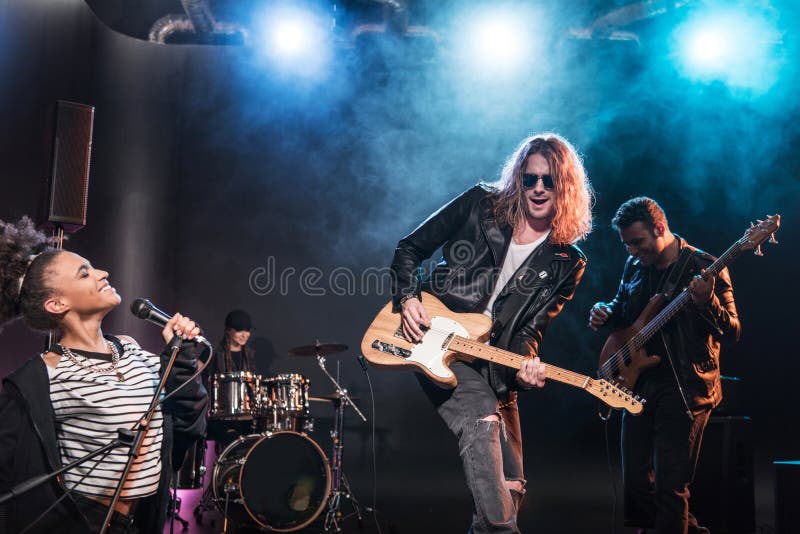 Singer with Microphone and Electric Guitar Players Performing Concert ...
