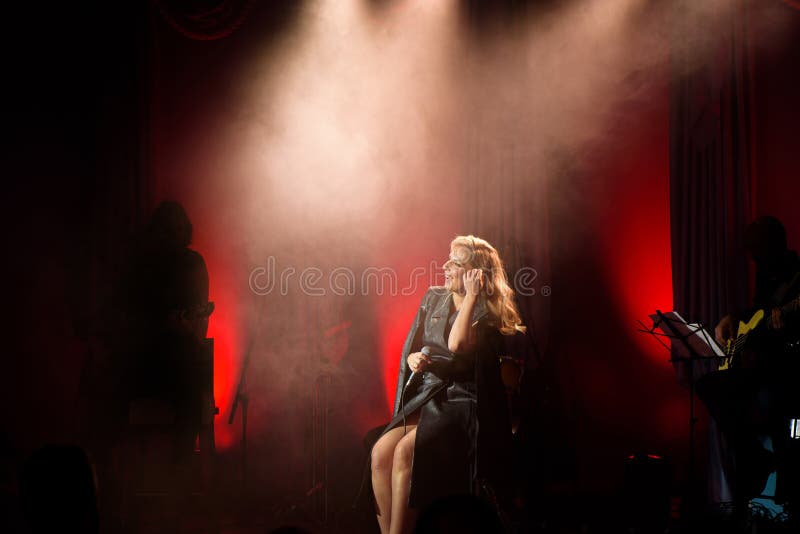 Singer with Microphone on the Stage in Stage Lighting Stock Photo ...