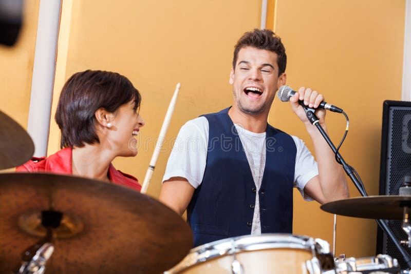 Singer Performing while Looking at Drummer Stock Photo - Image of ...