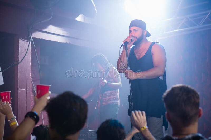 Male Singer Performing on Stage by Crowd at Nightclub Stock Image ...