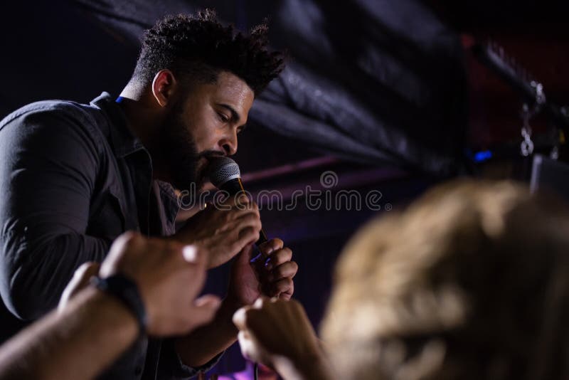 Singer performing on stage stock image. Image of crowd - 93236179
