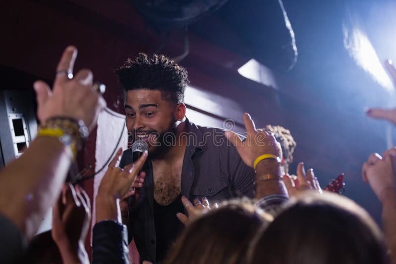 Singer performing on stage stock image. Image of clothing - 93236303