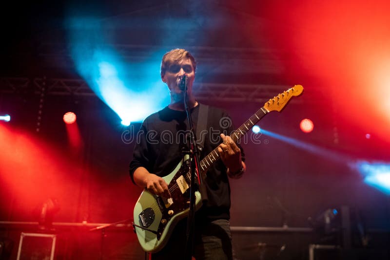 Singer Playing the Guitar and Singing during the Concert with Lights ...