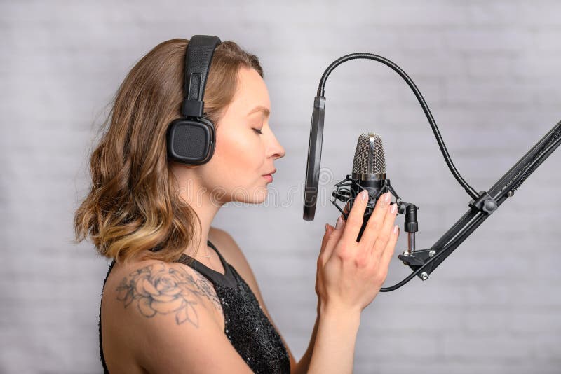 Singer Pop or Rock Music with a Tattoo, Works with a Studio Microphone ...