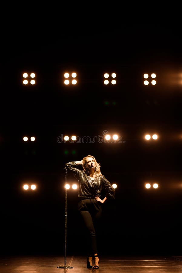 Singer on Scene in the Club. Bright Stage Lighting. Stock Photo - Image ...