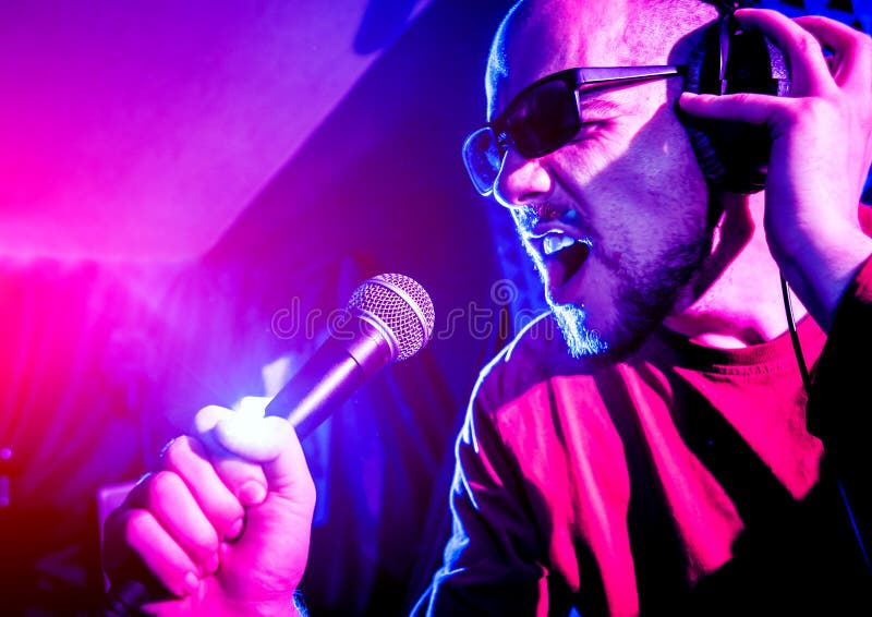 The Singer Sings with a Microphone in the Recording Studio. Stock Image ...