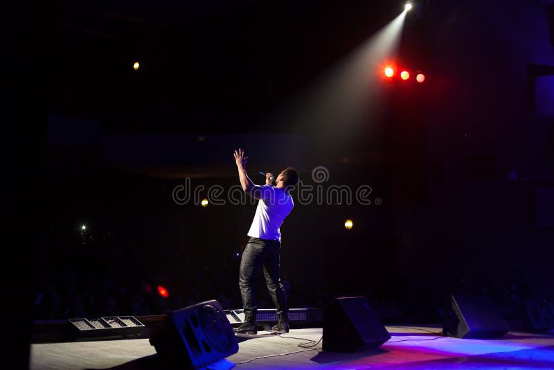 The Singer on Stage in the Spotlights Stock Photo - Image of ...