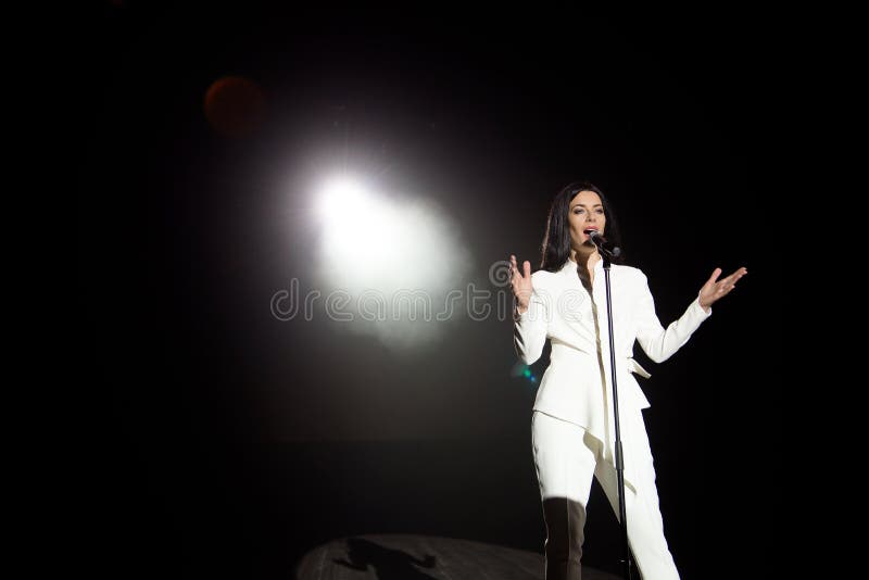 Singer Woman on Stage. Female Singer on the Stage Holding a Microphone ...