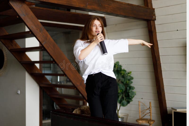 Singing and Dancing at Home, a Young Girl Imagines that she is a Singer ...