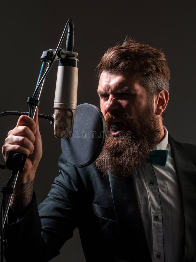 Singing Man in a Recording Studio. Expressive Bearded Man with ...