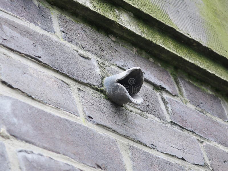 Singing Wall: Lead Pipe Coming Out Off a Brick Stone Wall Stock Photo ...