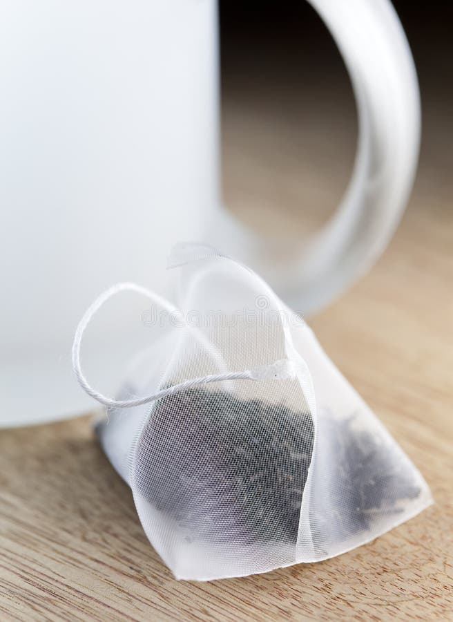 Single Bag of Elite Tea in Silk Fabric Packing and Tea Mug. Small Depth ...