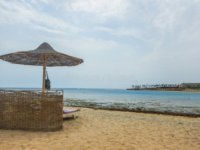 Single Beach Umbrella with a Sun Lounge at the Sandy Beach Stock Image ...