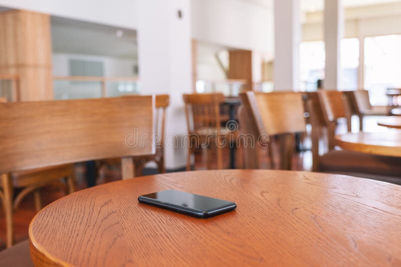 A Single Black Mobile Phone on the Table Stock Photo - Image of blur ...