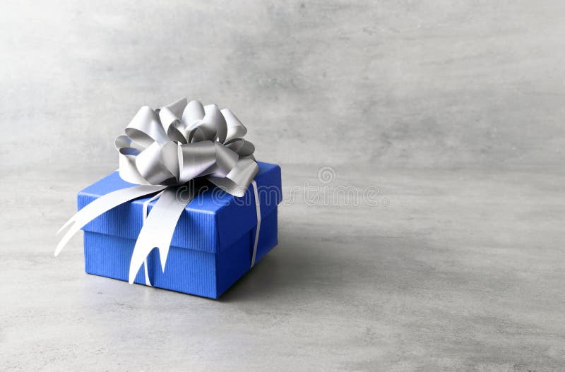 Single Blue Gift Box with Silver Ribbon on Gray Background Stock Image ...