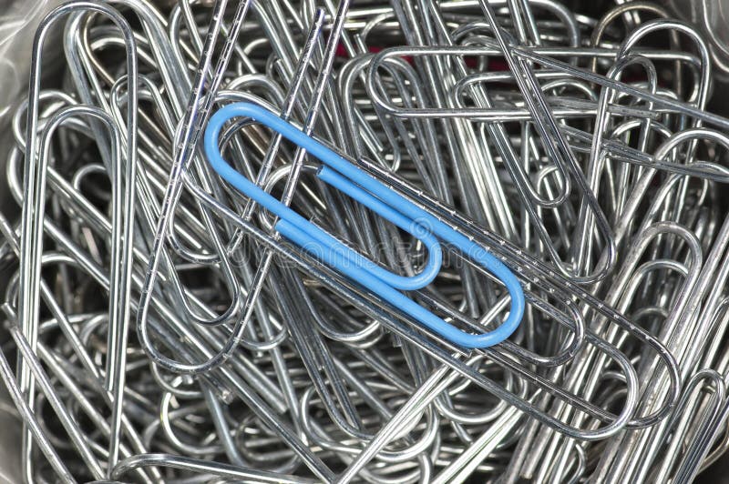 Lone Blue Paper Clip on a Stack of Silver Stock Image - Image of edges ...
