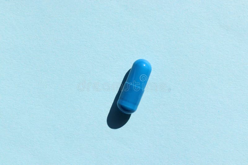 Single Blue Pill on a Blue Paper Background. Top View, Copy Space ...