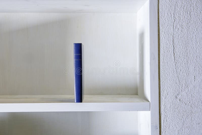 Single Book Standing Upright in White Shelf in White Wall Stock Image ...