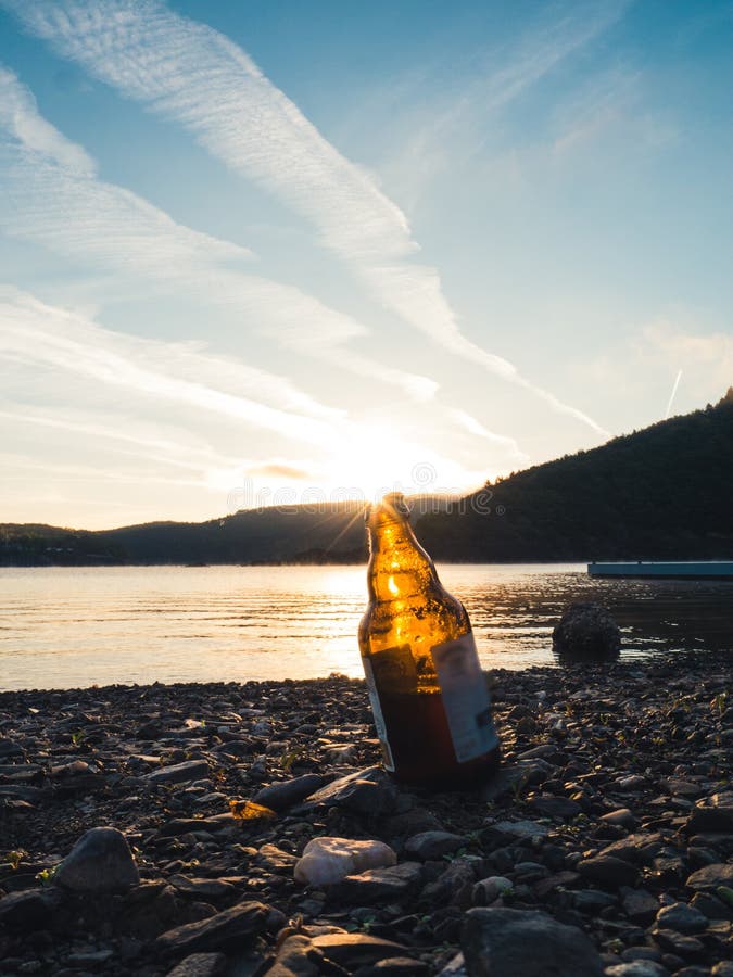 Single Bottle of Beer Standing on the Beach at Sunrise Stock Photo ...
