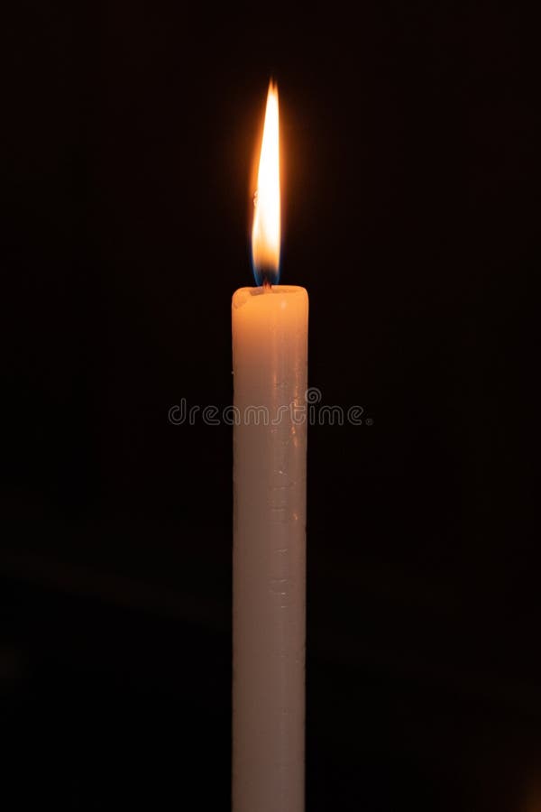 Single Burning Candle in the Foreground Stock Image - Image of shrine ...