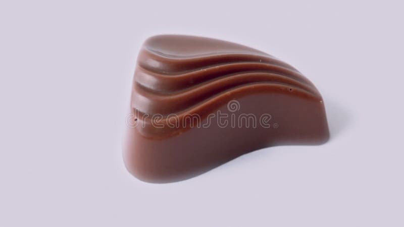 Single Chocolate Candy with Wavy Shape Rotates, Stock Footage - Video ...