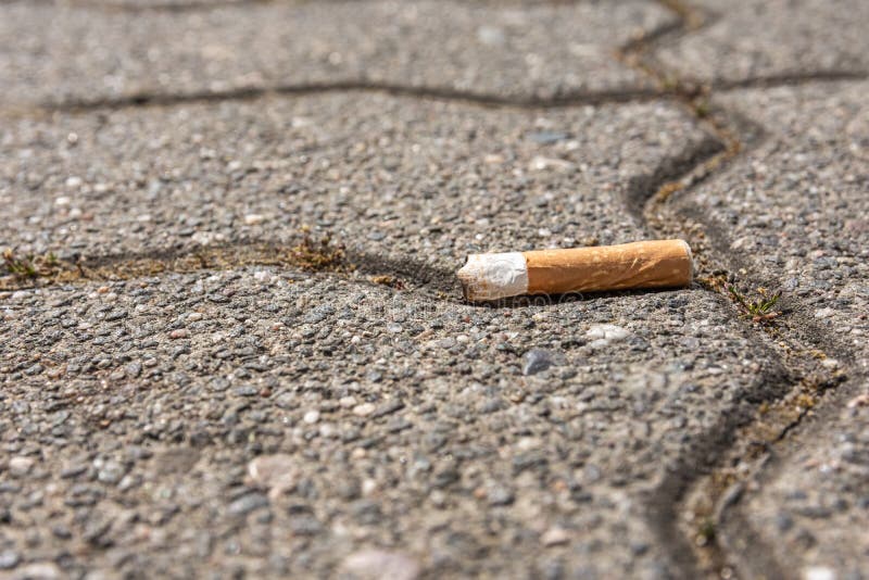 A Single Cigarette Lying on the Ground Stock Image - Image of focus ...