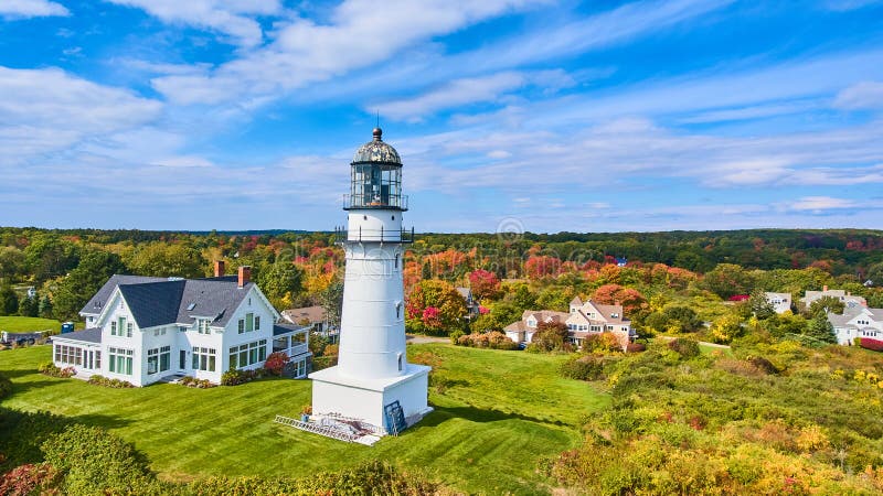 Single Classic White Lighthouse by Homes with Fall Foliage Around Stock ...