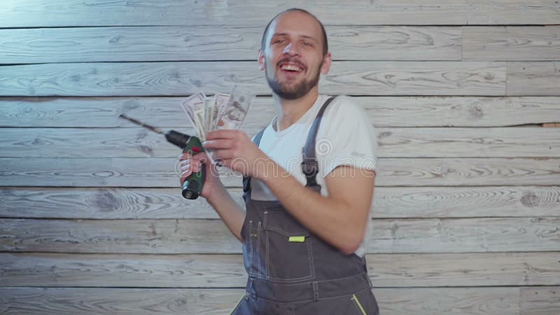 Dancing Construction Worker with Money and Drill in His Hand Stock ...