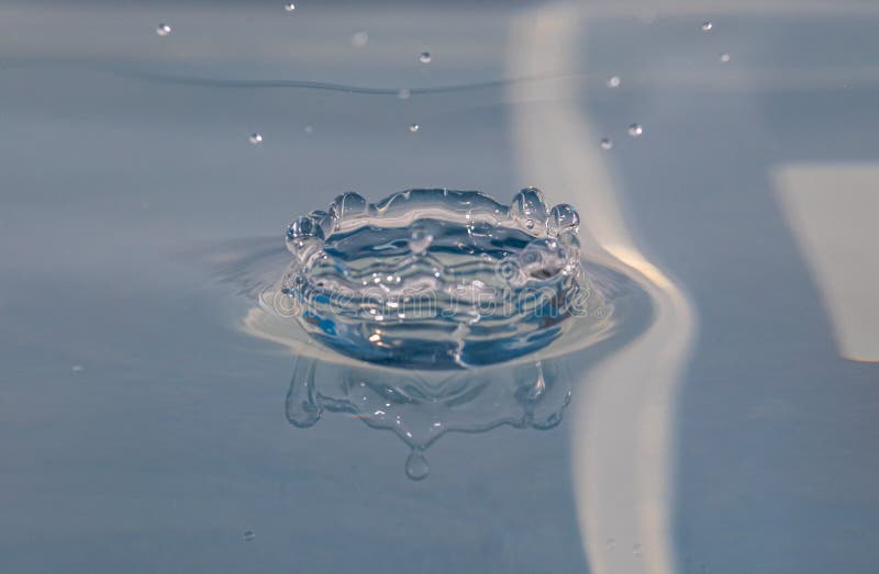 Single Drop of Water Falls into the Water from Above Stock Photo ...