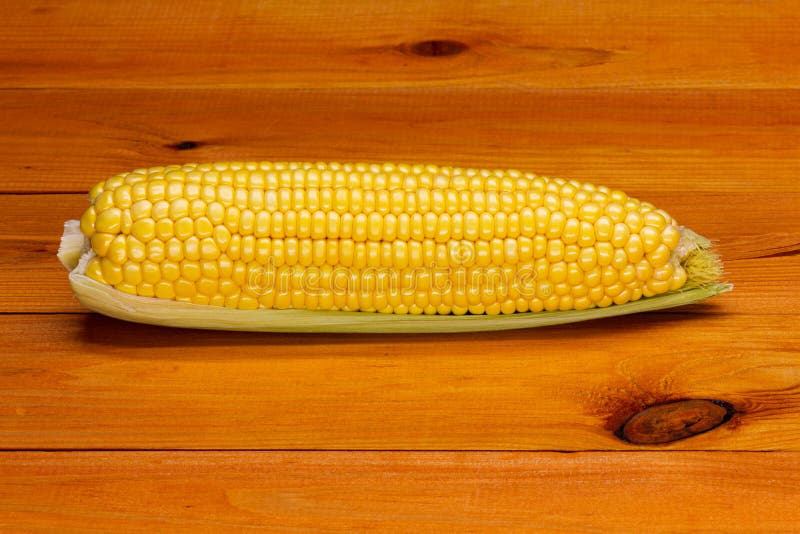 Single Ear of Corn on the Background of a Beautiful Wooden Table ...