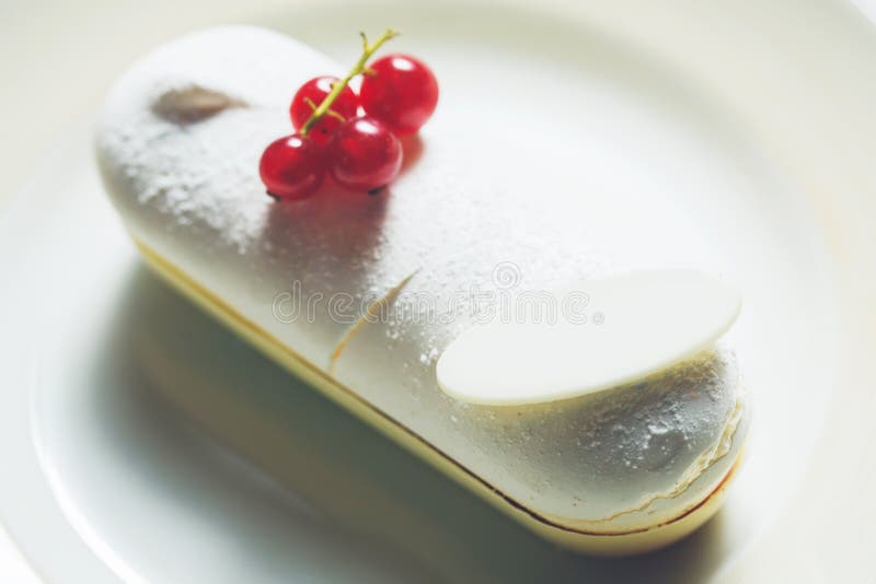 Single Eclair with Space for Text on White Plate. Stock Photo - Image ...