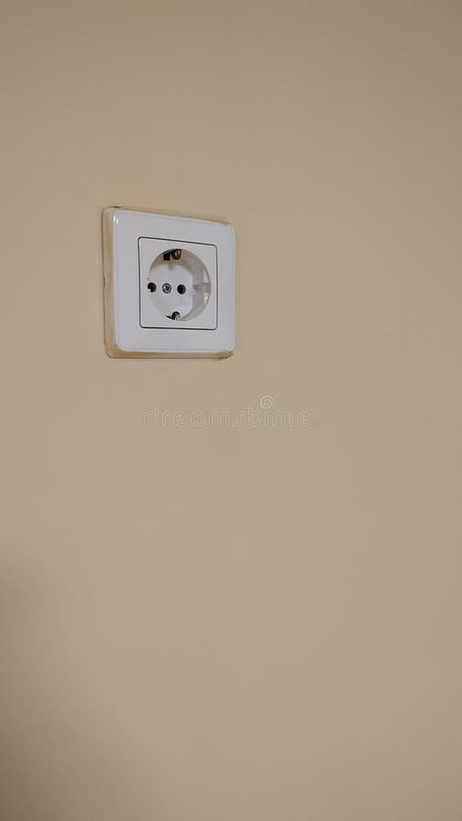 Single Electrical Outlet on the Wall Painted in Beige Color. Close-up ...