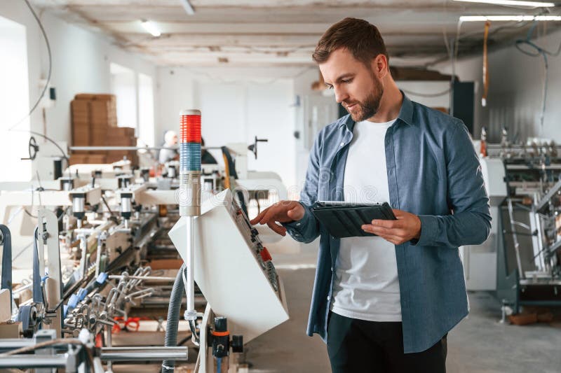 Single Employee. Handsome Man is Working at the Factory of Creating Eco ...