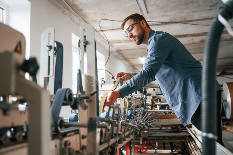 Single Employee. Handsome Man is Working at the Factory of Creating Eco ...