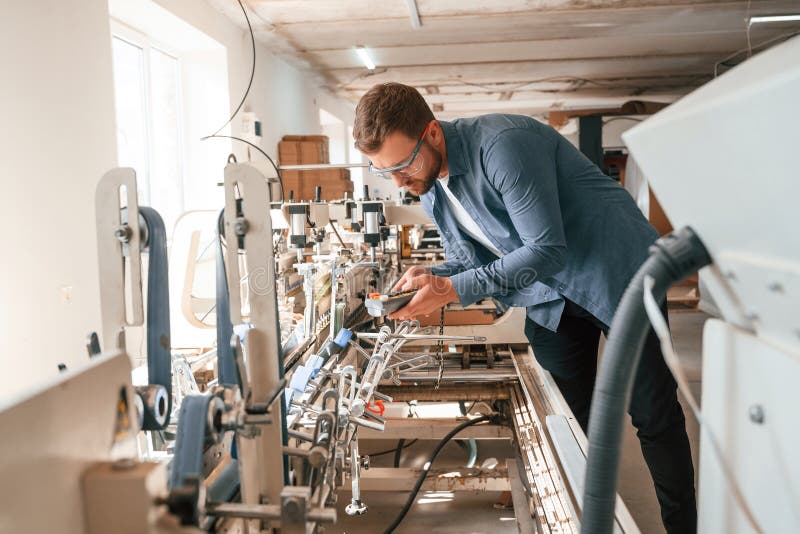Single Employee. Handsome Man is Working at the Factory of Creating Eco ...