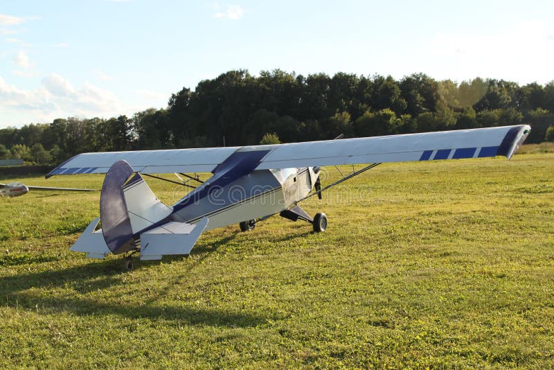 Single-engine Aircraft is on the Field Illuminated by Sunlight I Stock ...