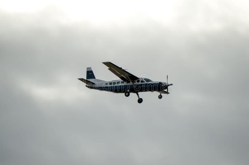 Single-engine Airplane Soaring Against a Cloudy, Gray Sky Background ...