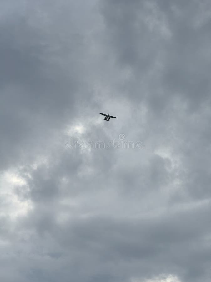 A Single-engine Floatplane Flying in a Cloudy Sky Stock Image - Image ...