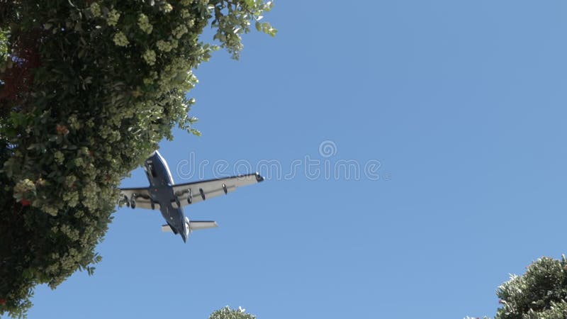 The Plane is Flying Against a Background of Blue Sky and Sun Stock ...