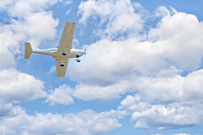 Single Engine Ultralight Plane Flying in the Cloudy Blue Sky Stock ...