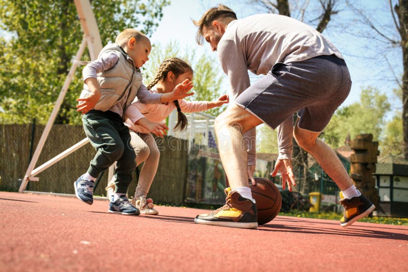 Single Father with His Children. Stock Photo - Image of dribbling ...