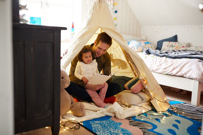 Single Father Reading with Daughter in Den in Bedroom at Home Stock ...