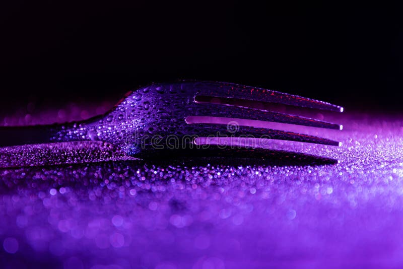 Single Fork with Waterdrops, in the Dark Illuminated with Colourful ...