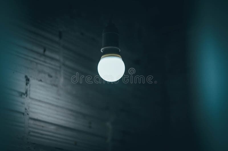 Single Glowing LED Bulb Hanging from Ceiling in a Dark Abandoned Room ...