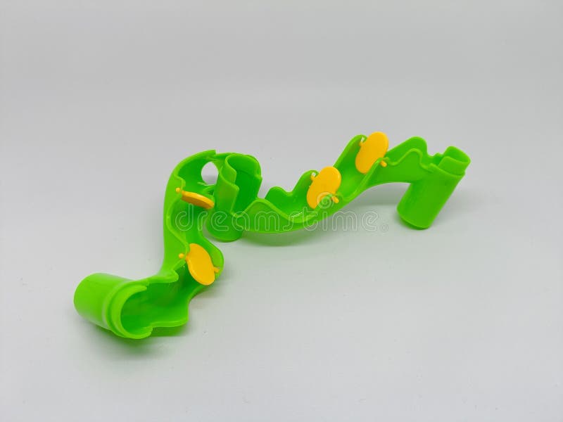 Green Curved Marble Run Track Piece with Yellow Connectors Stock Photo ...