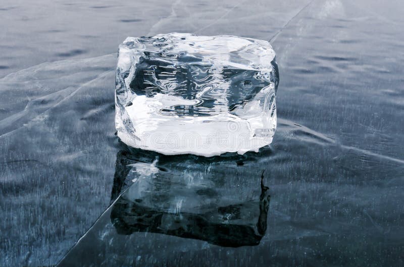 Single Ice Cube with Reflection on the Lake Surface Stock Photo - Image ...