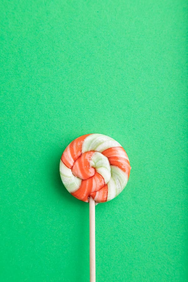 Single Lollipop Candy on Green Background. Copy Space, Top View Stock ...