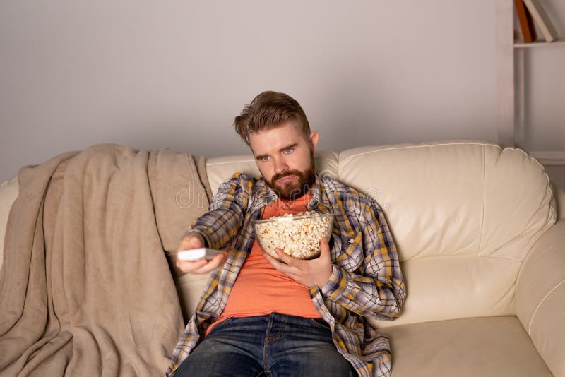 Single Man on the Couch Watching TV Stock Image - Image of hand, couch ...