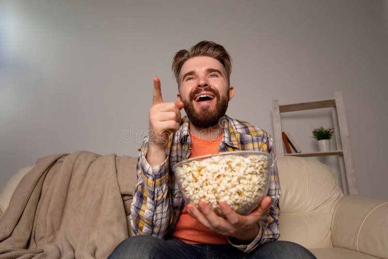 Single Man on the Couch Watching TV Stock Photo - Image of film, hand ...