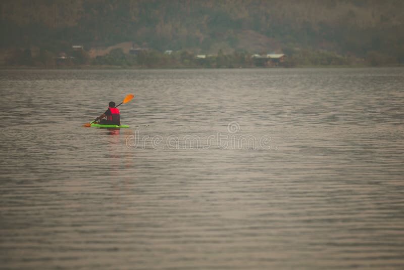 Single Man Play Kayak Boat Alone at Evening Time at Lake. Stock Photo ...